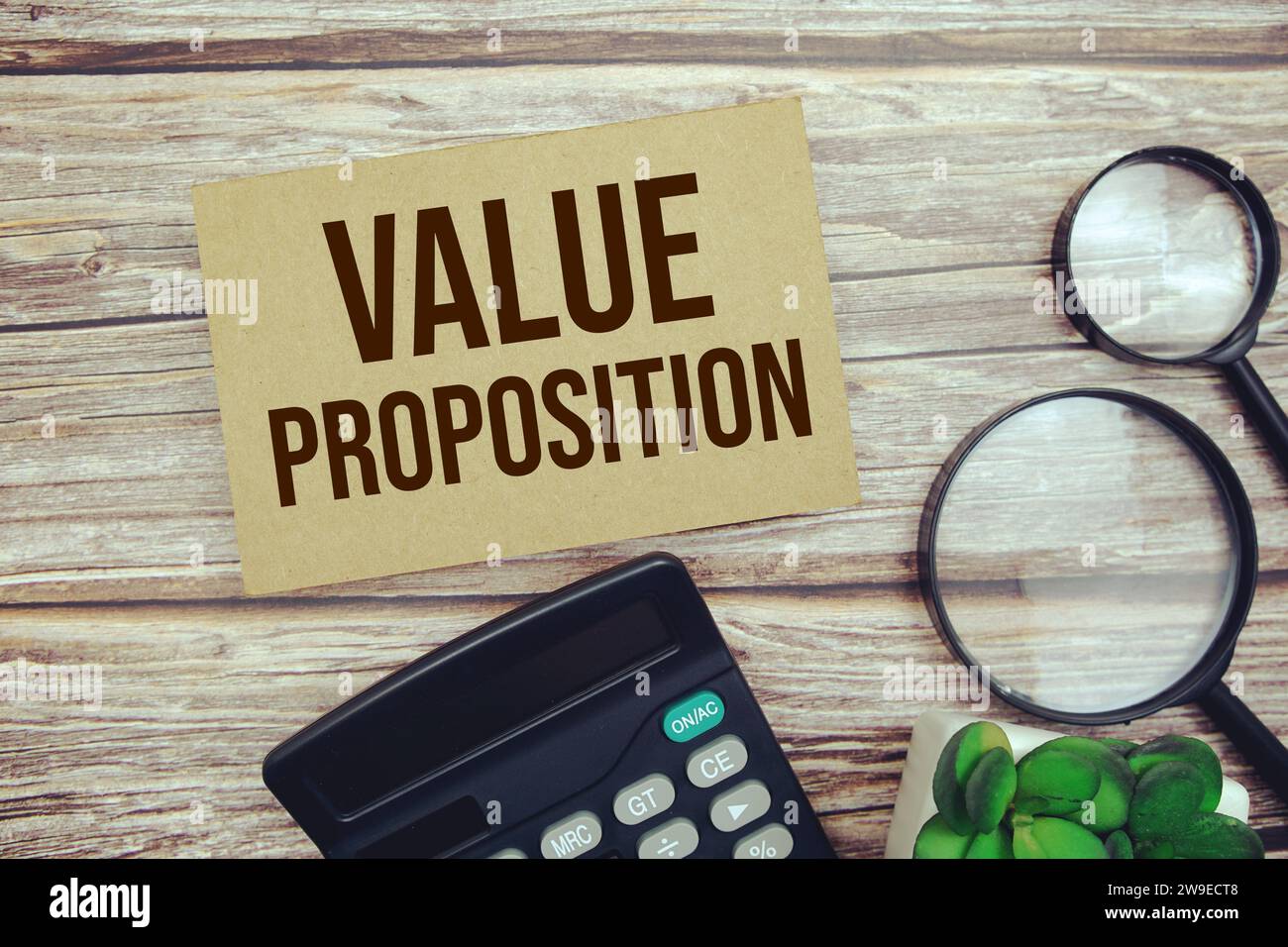 Value Proposition text message with calculator and magnifying top view ...