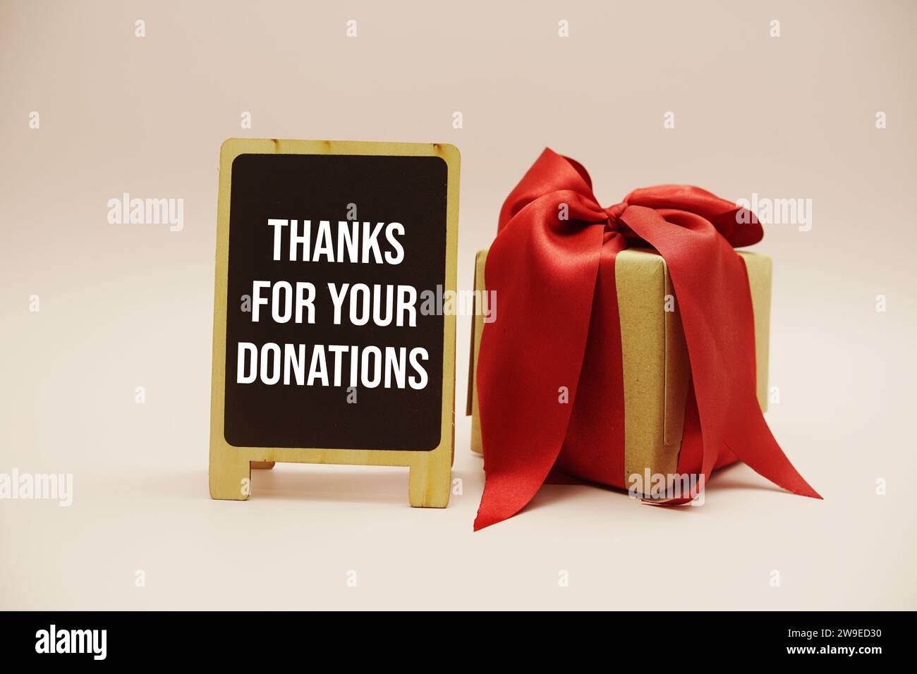 Thanks for your donations text message write on blackboard and gift box ...