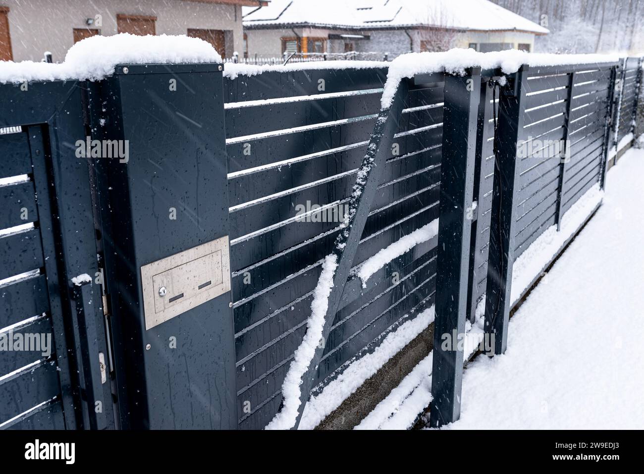 A modern gate with a letterbox and a wireless card reader, mounted in ...