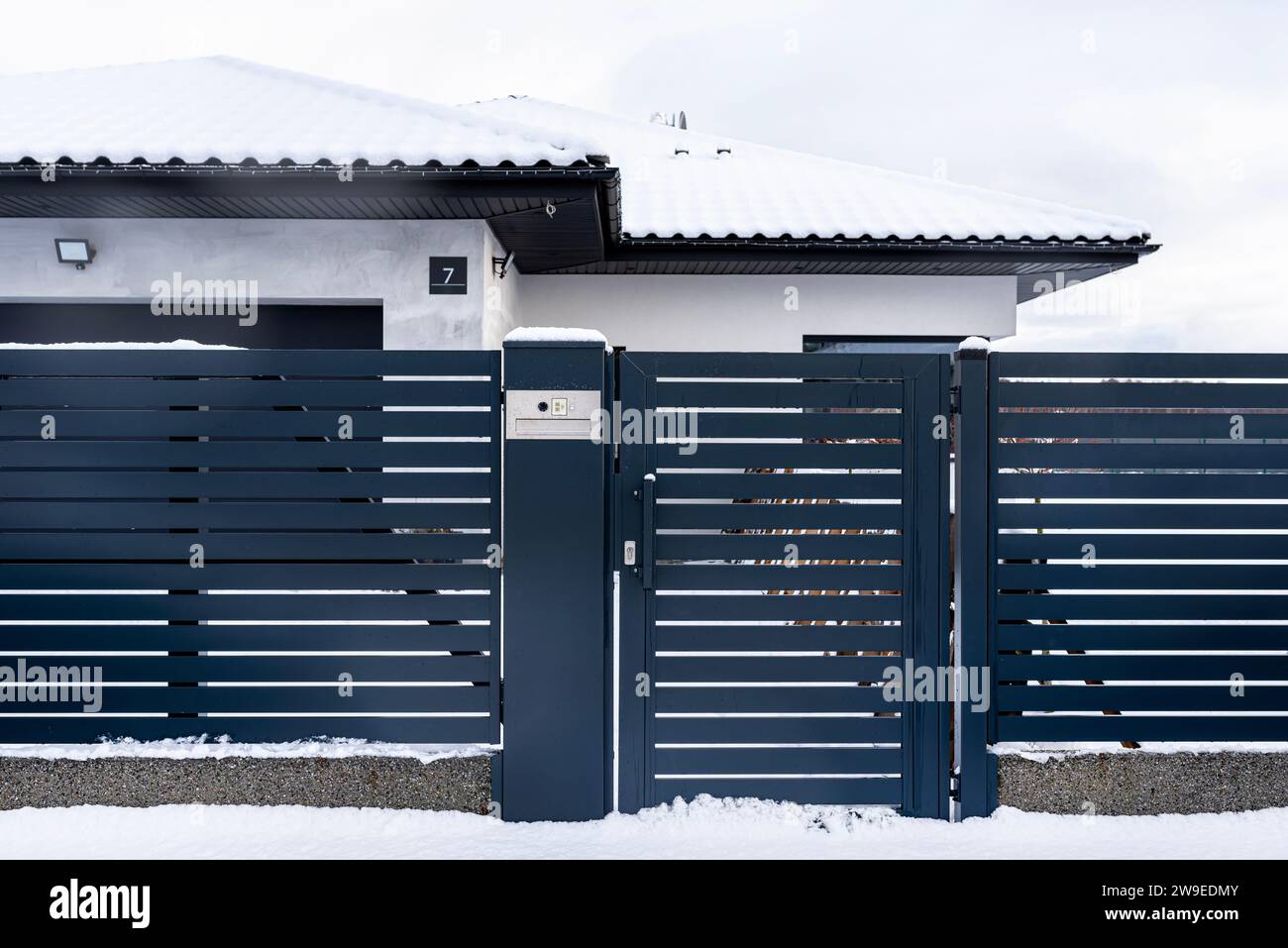 A modern gate with a letterbox and a wireless card reader, mounted in ...