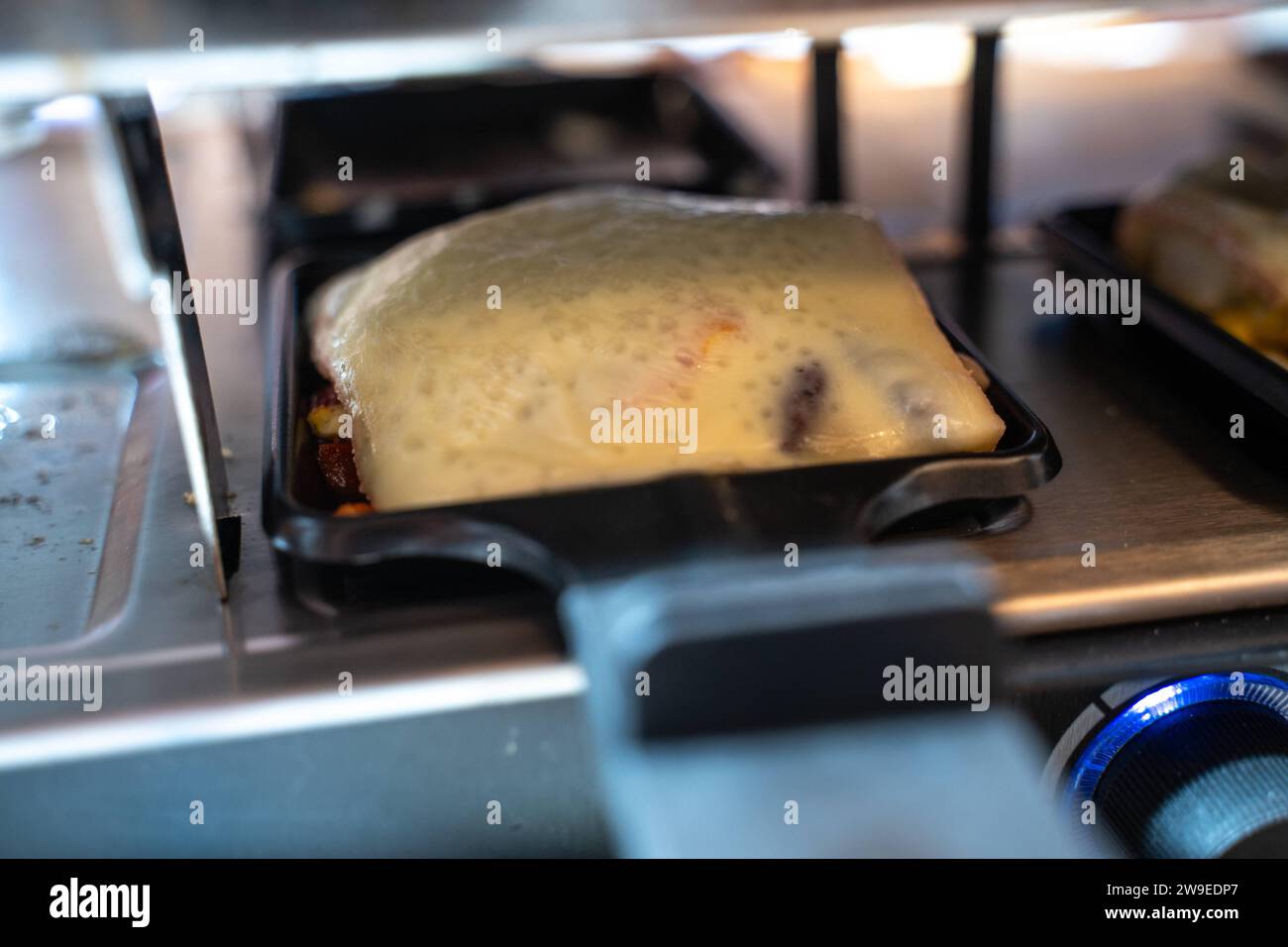 Bavaria, Germany - December 24, 2023: Raclette cheese melting in an ...