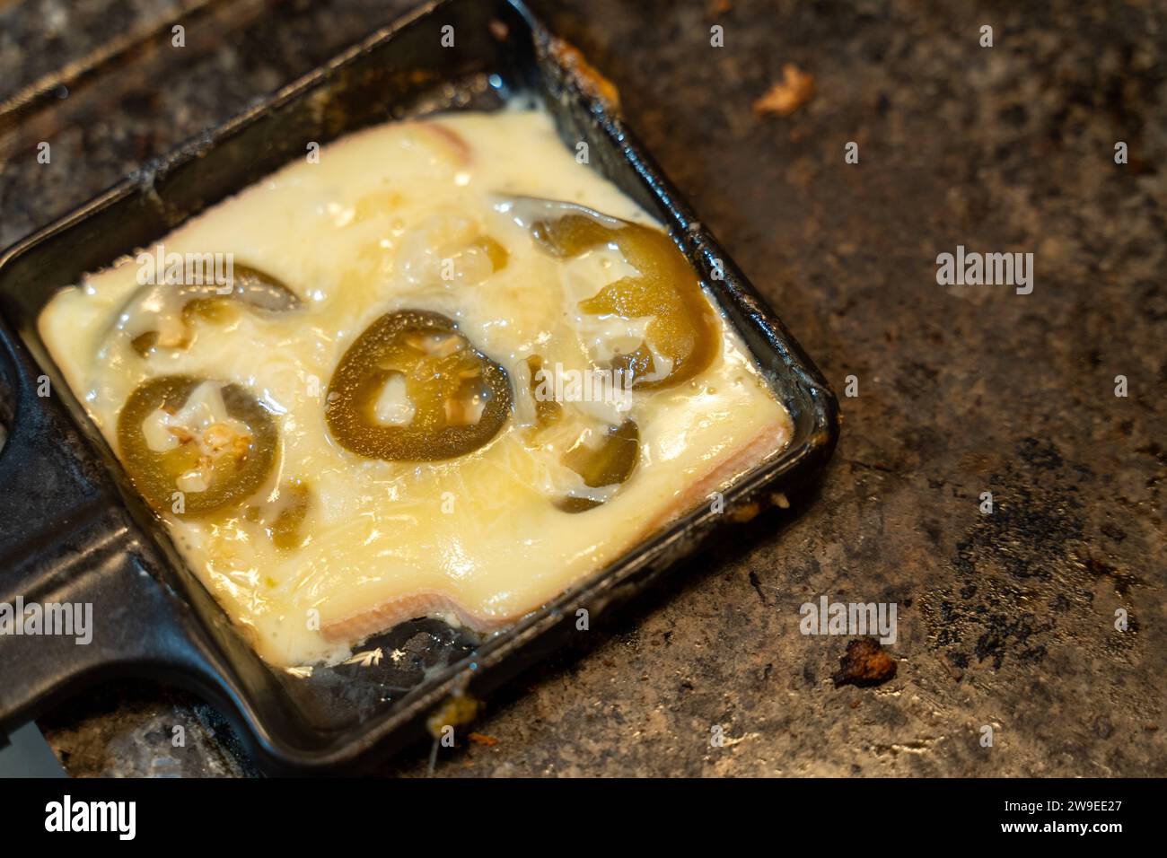 Bavaria, Germany - December 24, 2023: Cheese melts in a pan at a ...