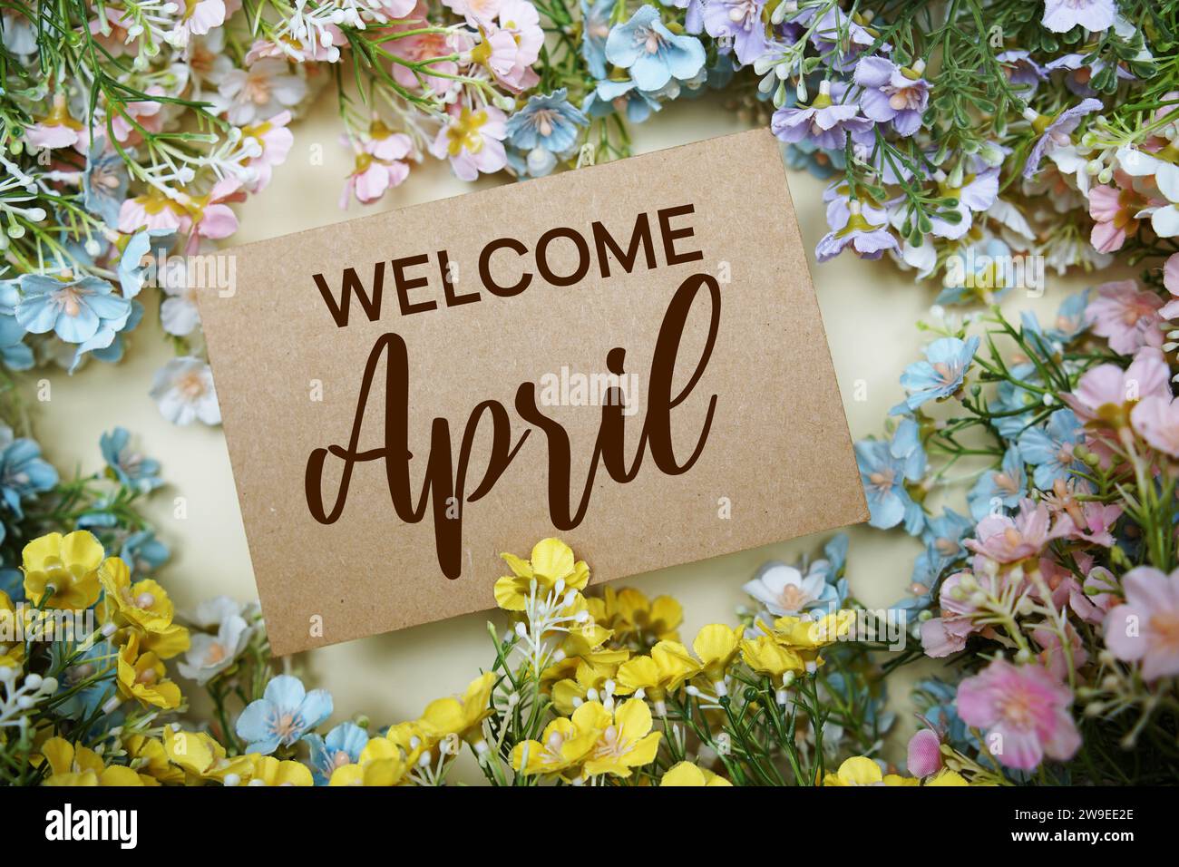 Welcome April text message with flower decoration on yellow background ...