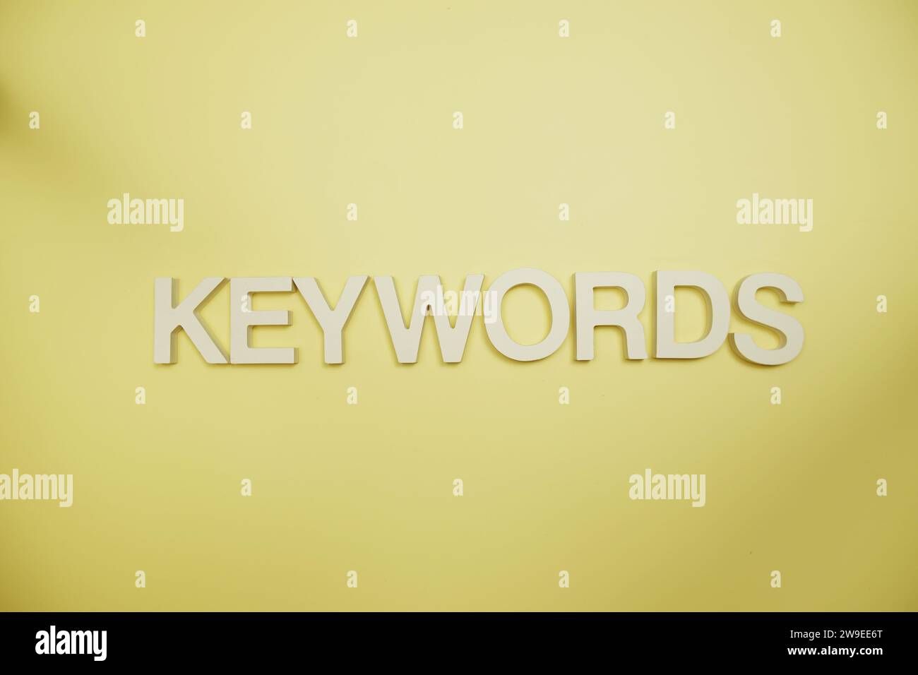 Keywords alphabet letters on yellow background Stock Photo - Alamy