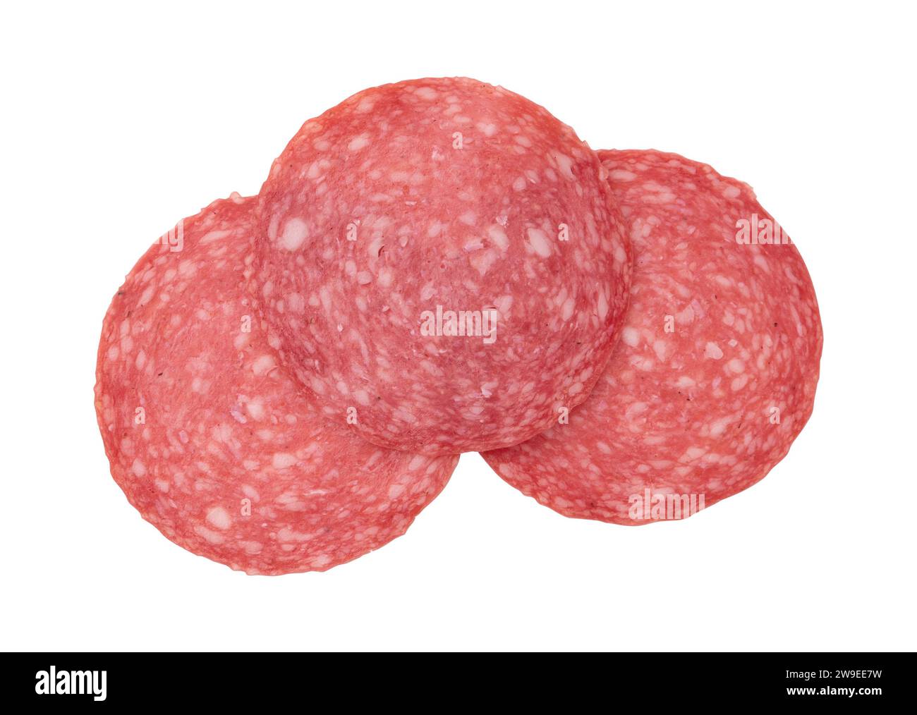 three pieces of sliced salami sausage laid out to create layout, salami sausage slices isolated ...