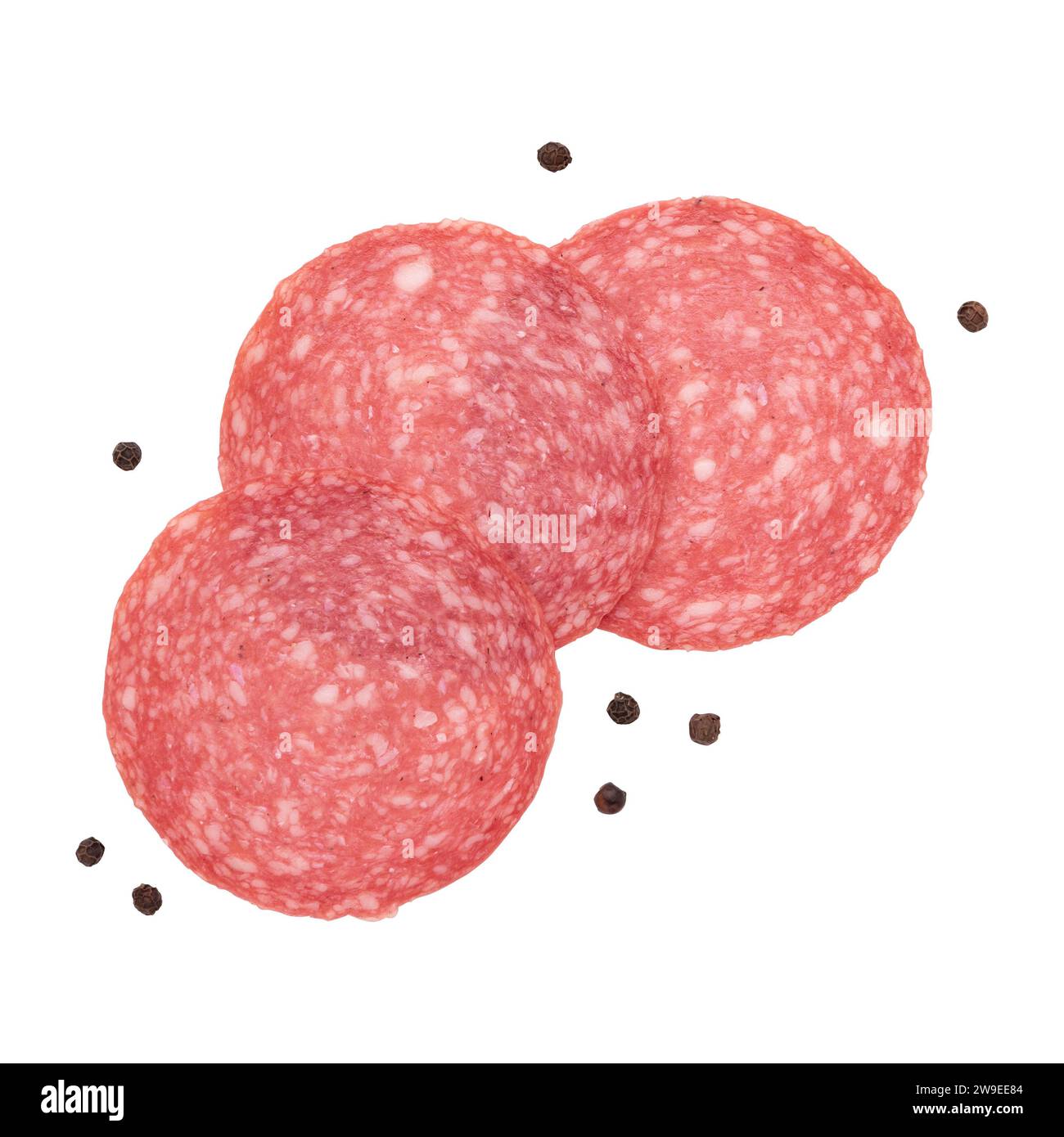 three pieces of sliced salami sausage with black pepper peas as seasoning laid out to create ...