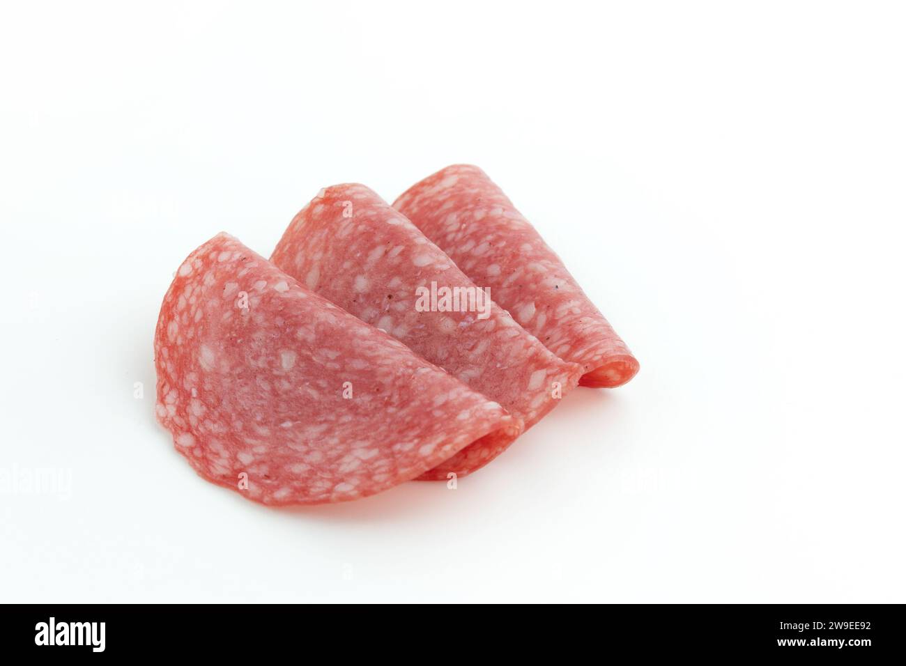 salami sausage slices isolated on white background, pieces of sliced salami sausage laid out to ...