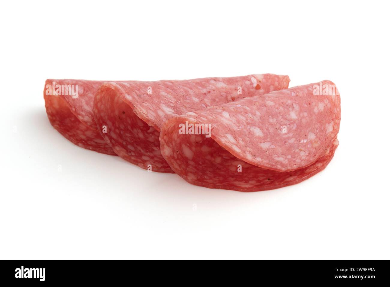 salami sausage slices isolated on white background, pieces of sliced salami sausage laid out to ...