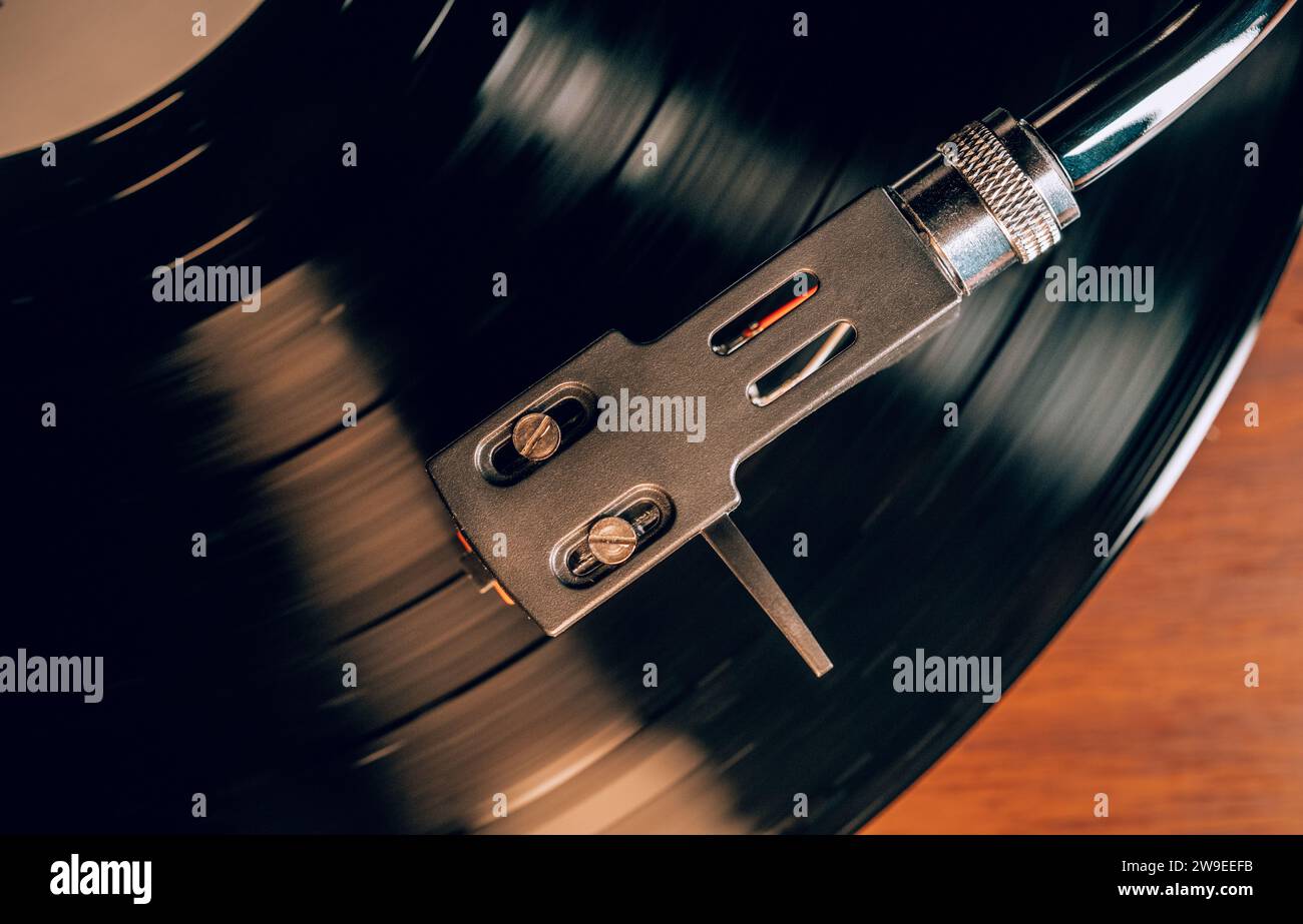 Classic stylus needle traces grooves of vinyl record. Music nostalgia ...