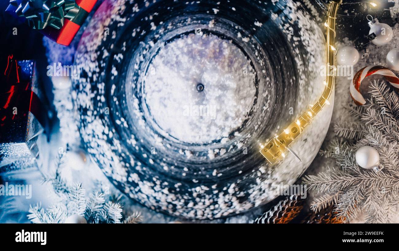 Classic vinyl record spinning in Christmas decorations. Fusion of ...