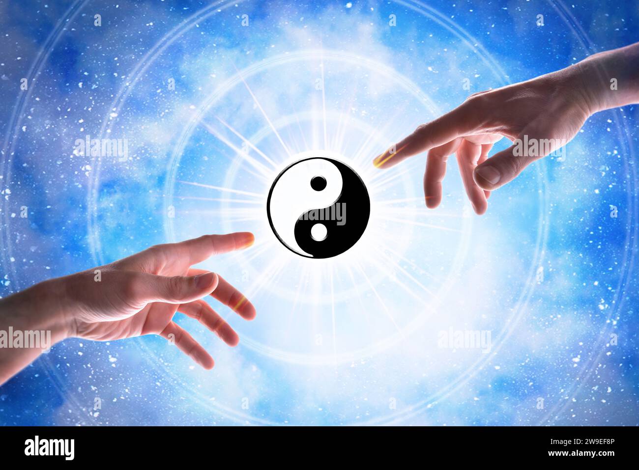 Hands pointing taoist symbol with concentric circles with a flash of ...