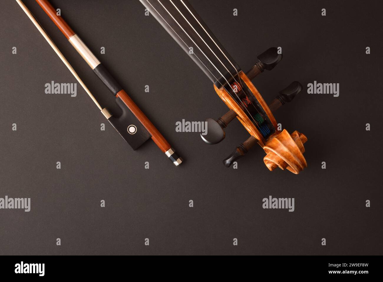 Detail of peg box and neck of traditional stringed violin and bow on ...