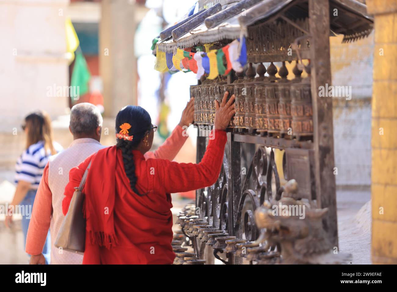 Kathmandu, Nepal- November 19 2023: woman push the prayer wheel in ...