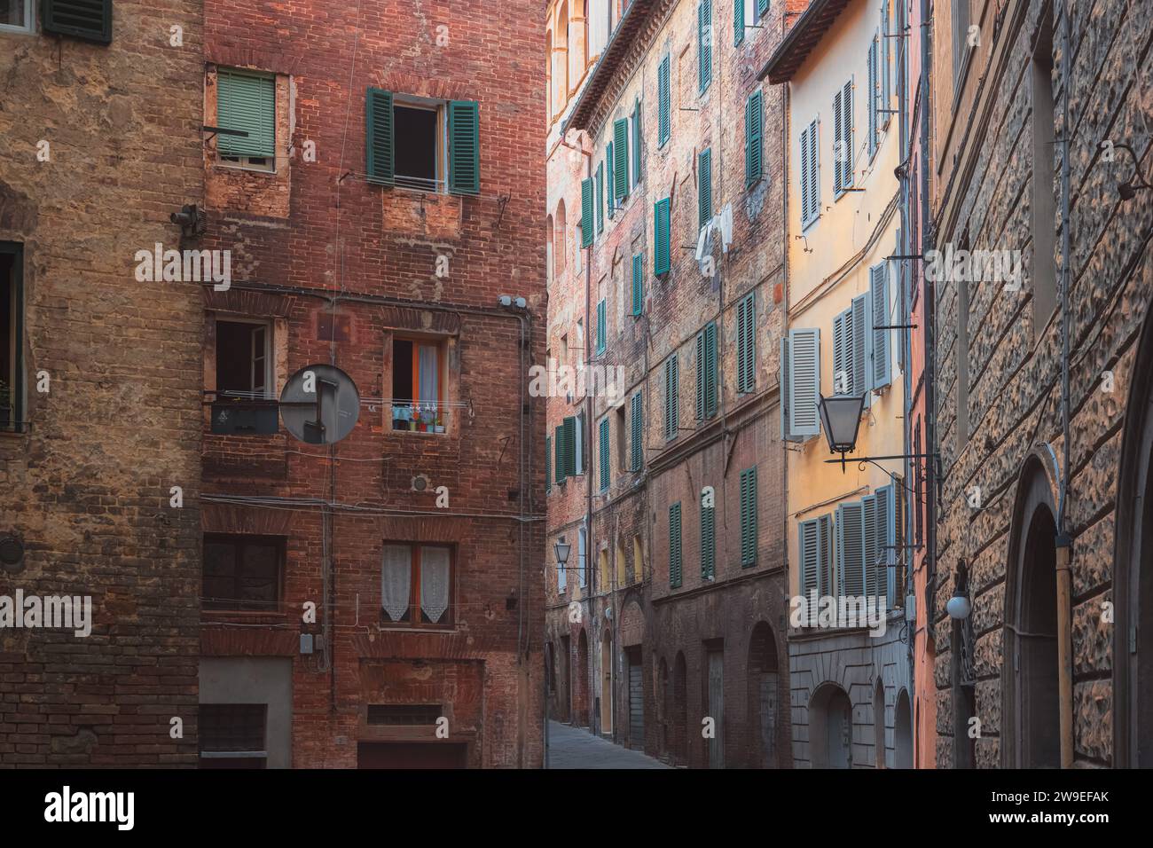 Colourful residential buildings along a quaint and narrow backstreet in ...