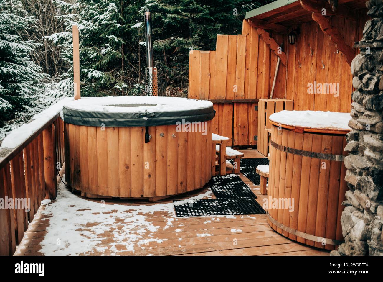 Open-air bath interior near forest, winter, snow view. Wooden hot tub ...
