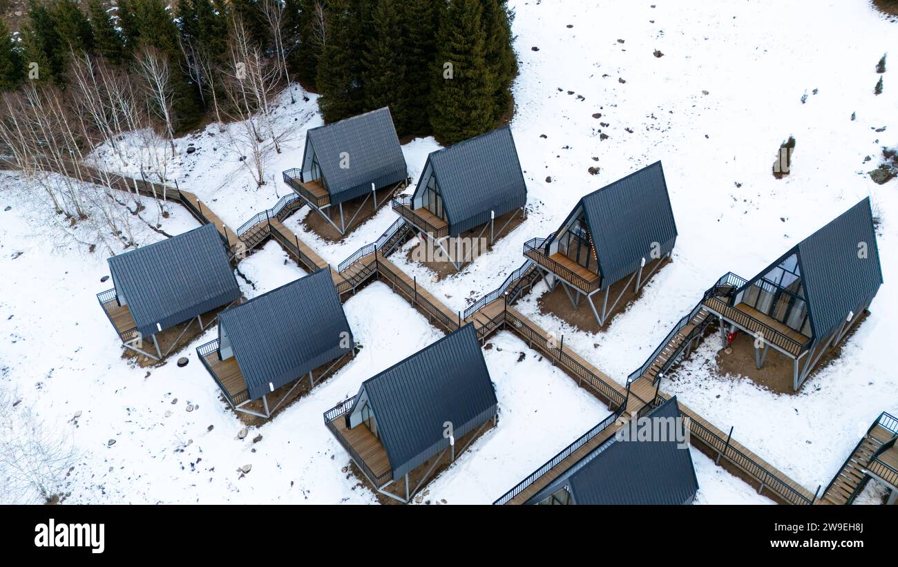 Aerial view of A Frame cabins on hill in the winter park Stock Photo ...