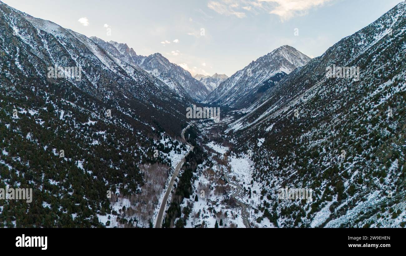 Aerial view of snow capped mountains and fir trees in the Ala-Archa ...
