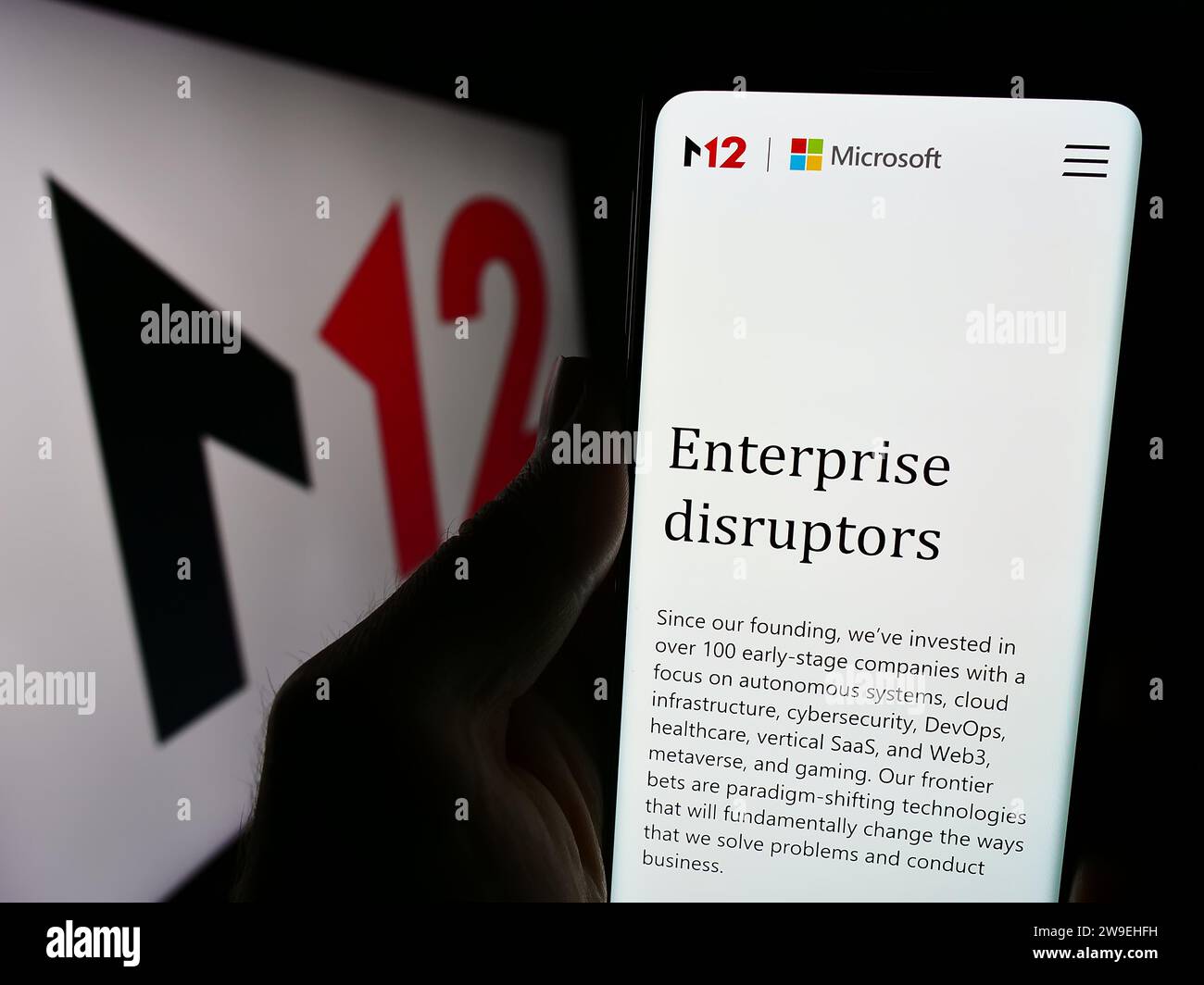 Person holding mobile phone with website of US venture capital company ...