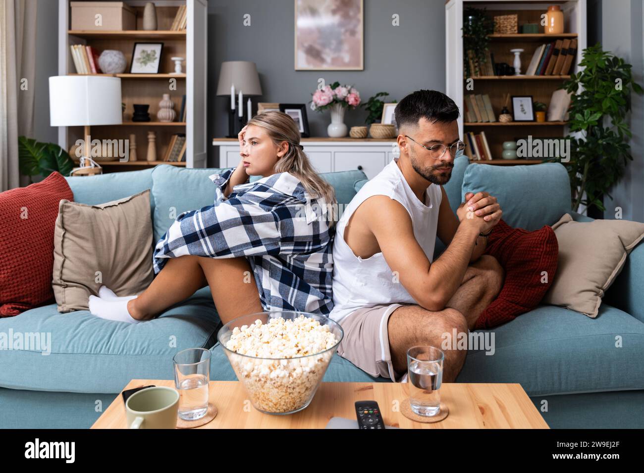 Stressed Young Married Couple Sitting Separately On Different Sides Of