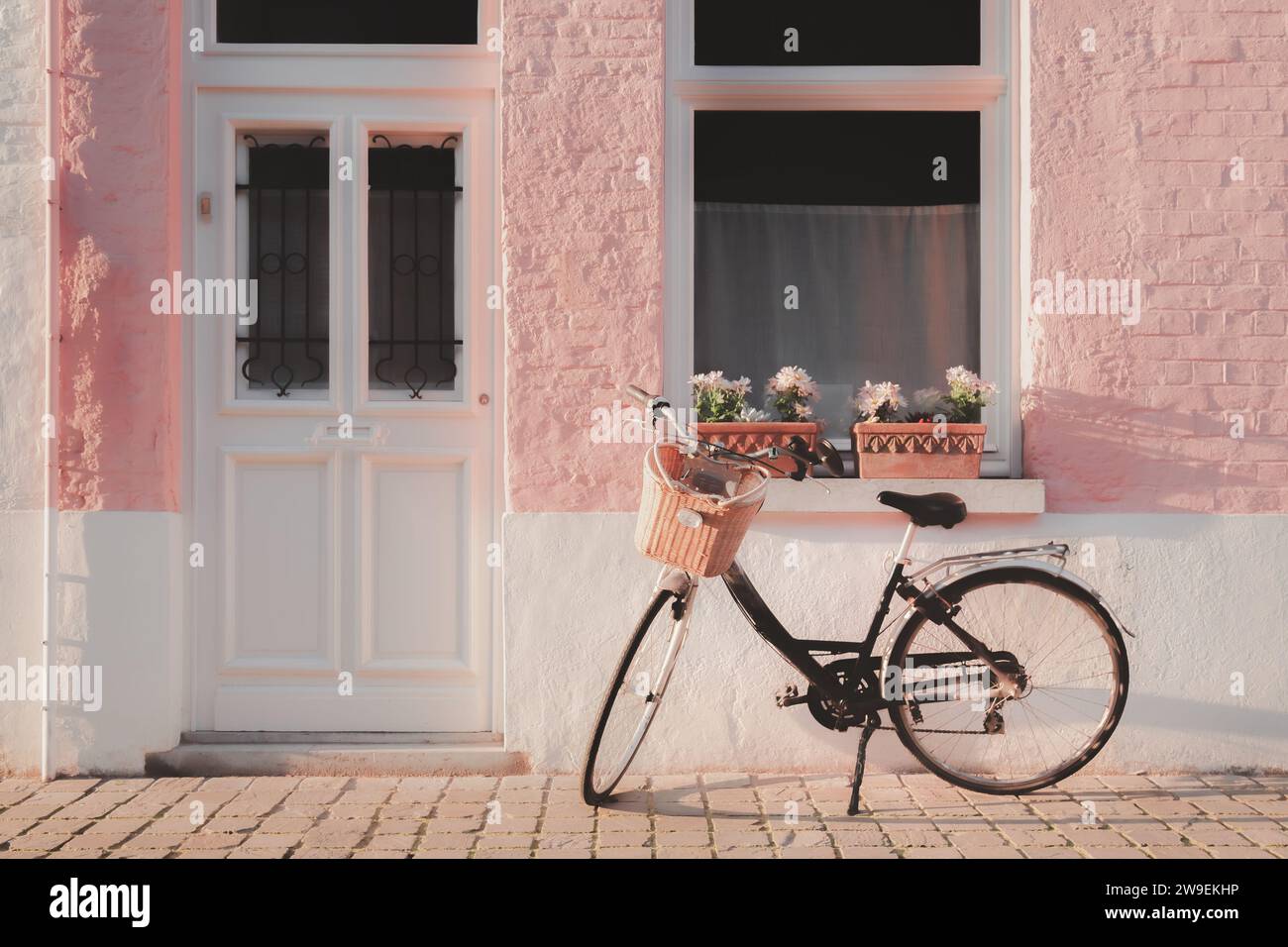 Vintage still life scene of a bicycle parked outside of quaint pastel ...