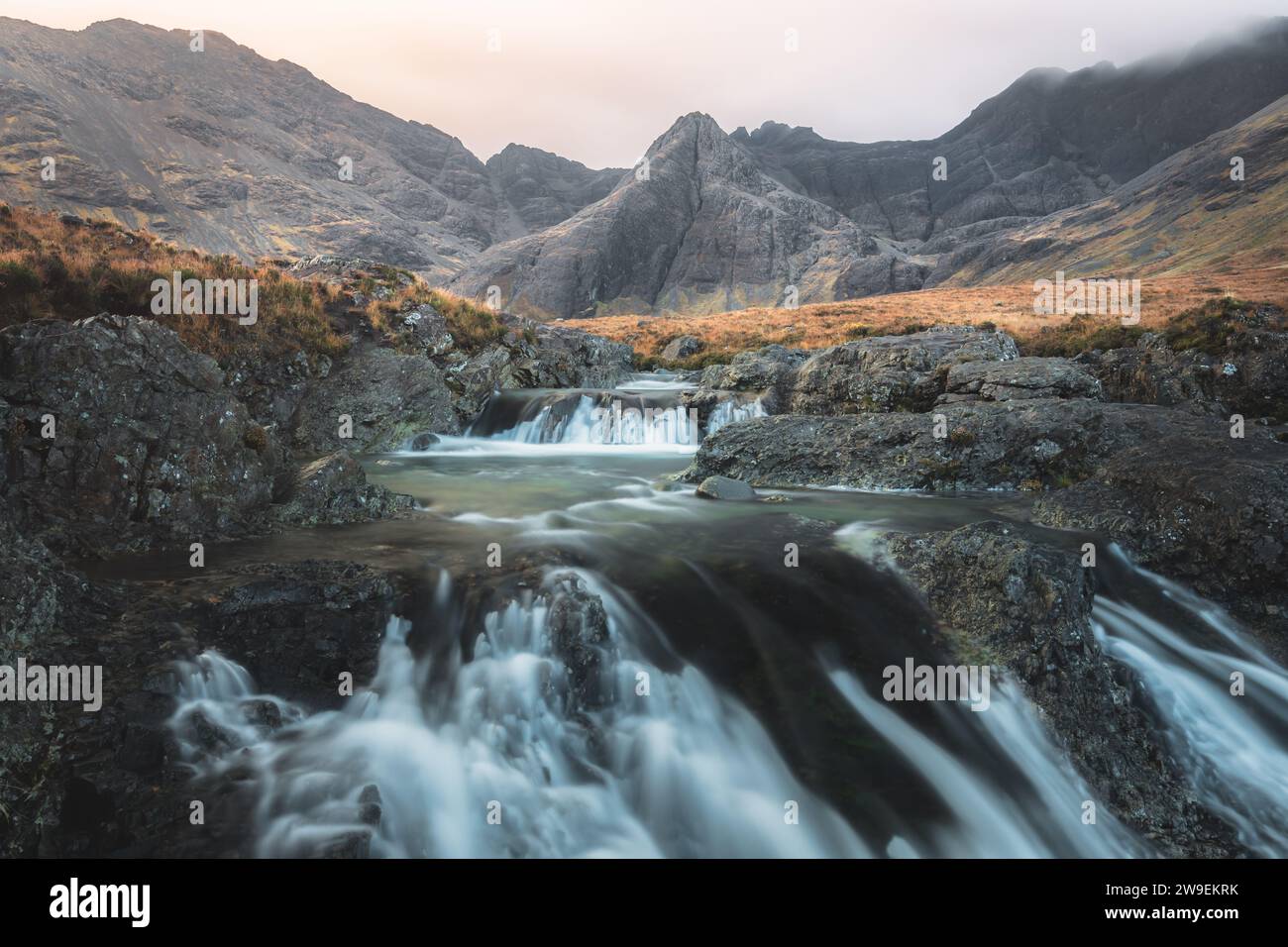 Moody, dramatic mountain and waterfall landscape of the Fairy Pools and ...