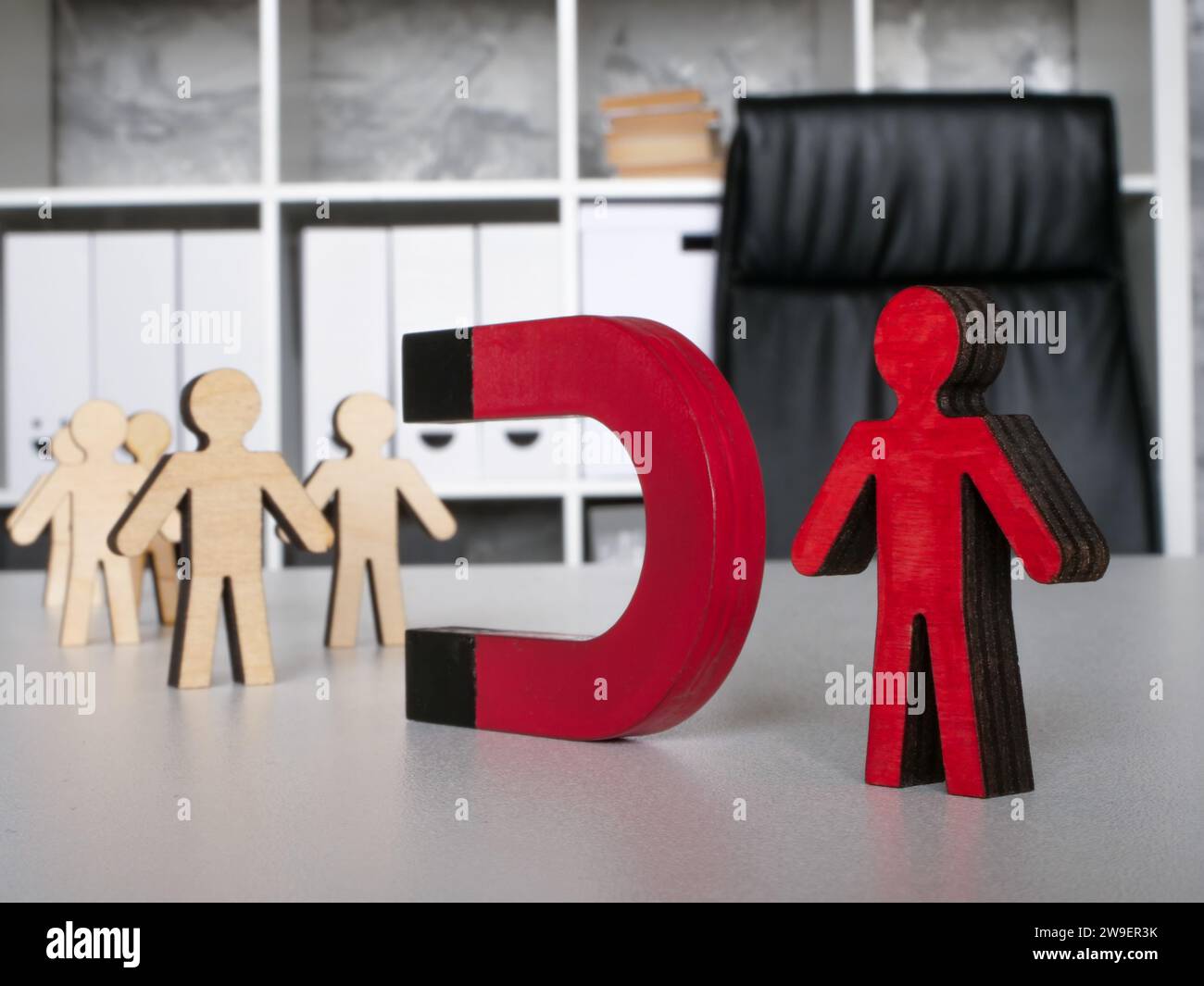 Employee retention concept. Boss with magnet Stock Photo - Alamy