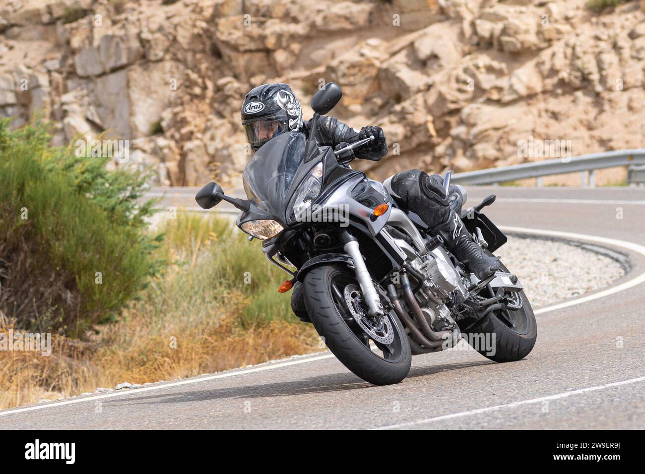 man on his motorcycle taking a sharp curve in the port of Navalmoral ...