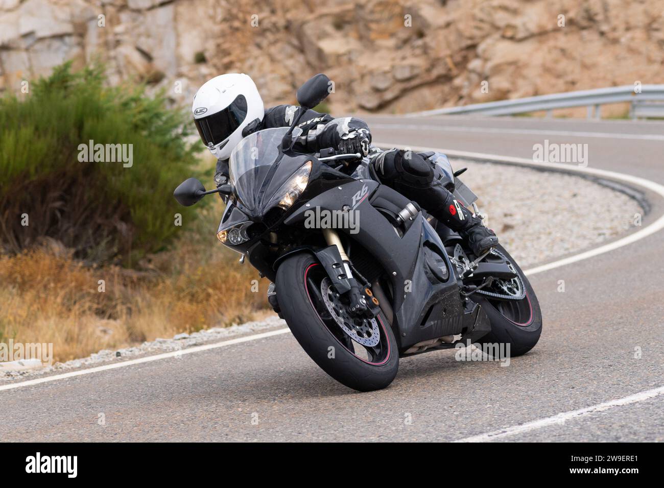 man on his motorcycle taking a sharp curve in the port of Navalmoral ...