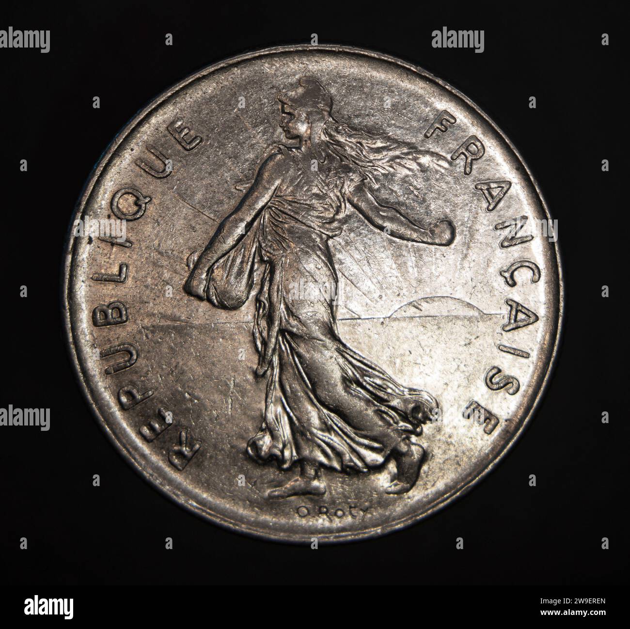 A silver French franc coin on a black background Stock Photo - Alamy