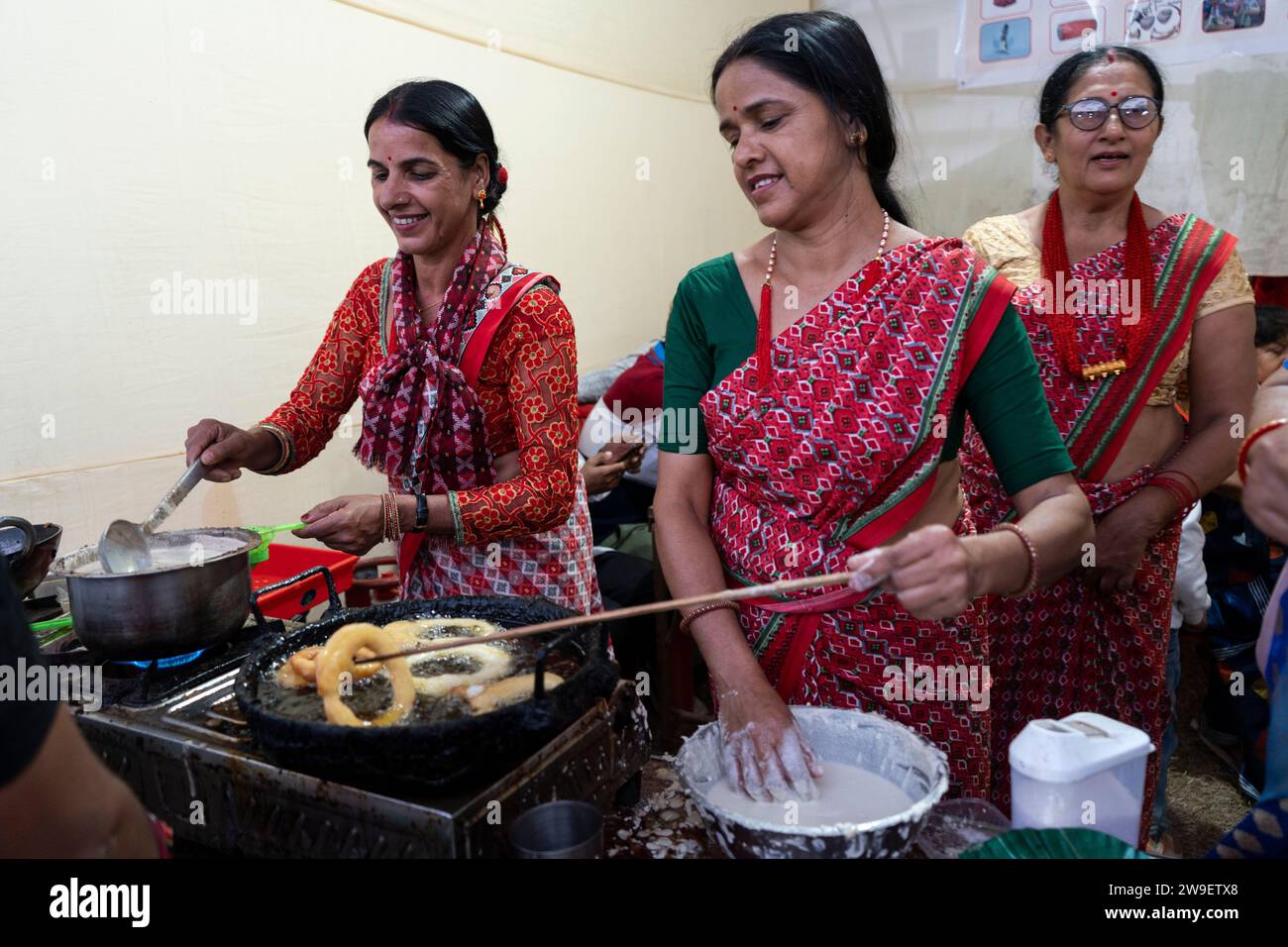 Nepali woman making traditional Sel Roti at a stall, during North East ...