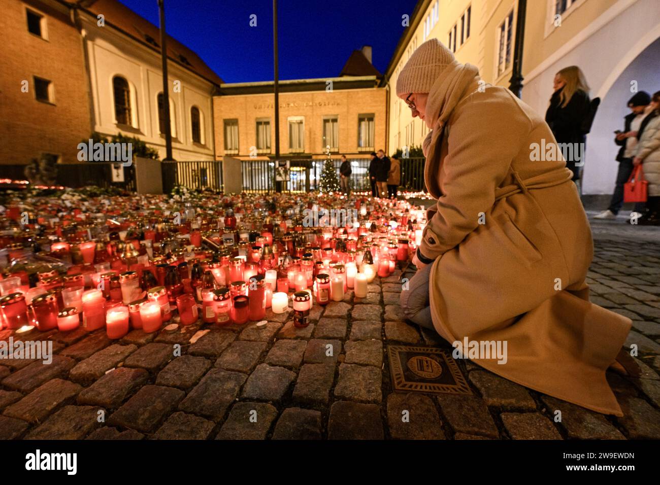 Prague, Czech Republic. 27th Dec, 2023. People light candles in front ...