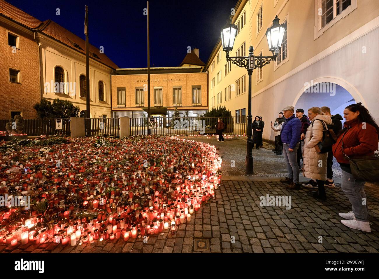 Prague, Czech Republic. 27th Dec, 2023. People light candles in front ...