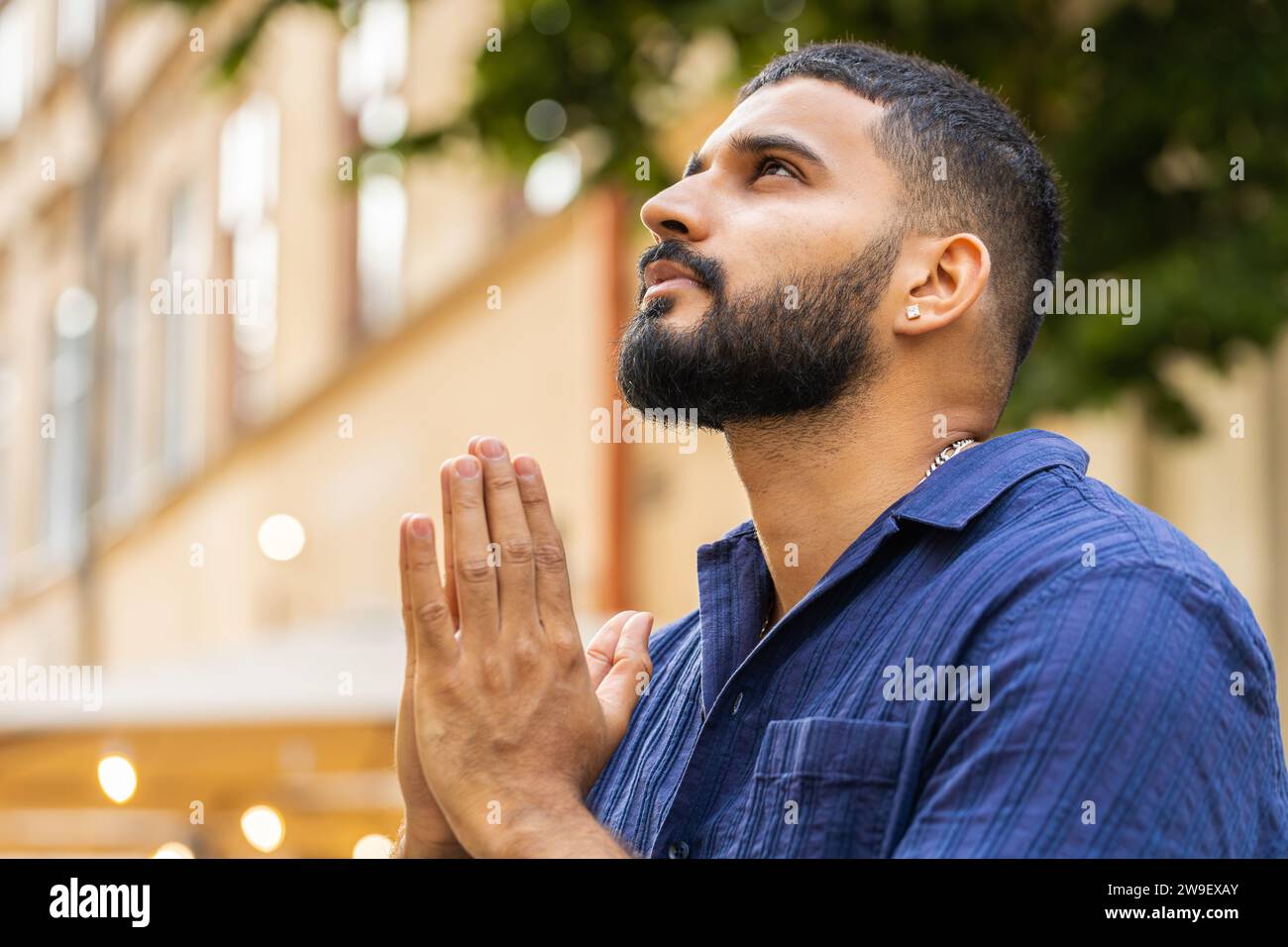 Portrait of bearded religion indian man praying with closed eyes to God ...