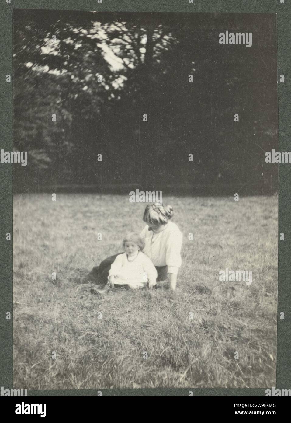 Mother and daughter sit on the grass, De Paauw estate, c. 1913 ...