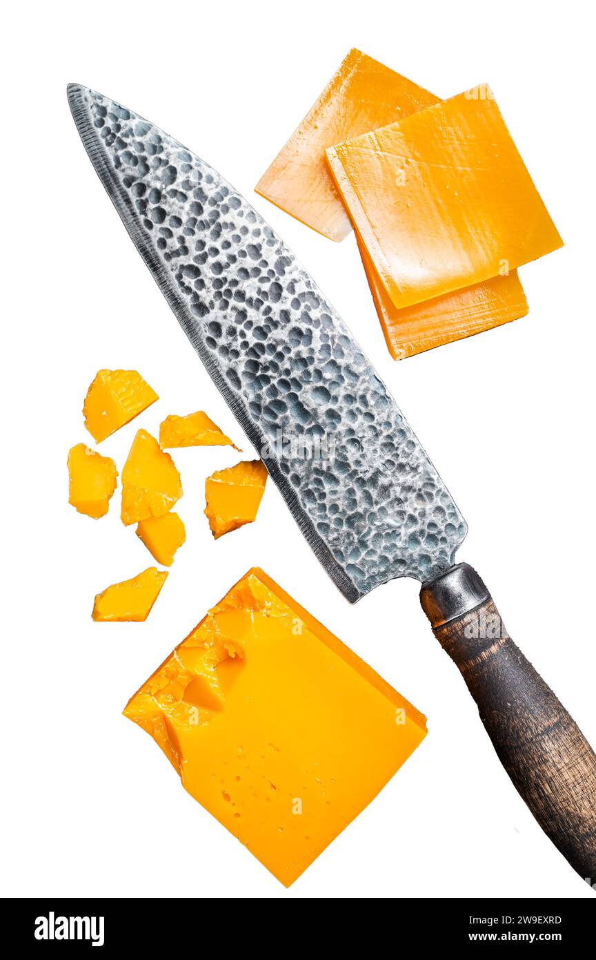 Cheddar Cheese sliced on a kitchen table with knife. Isolated on white ...