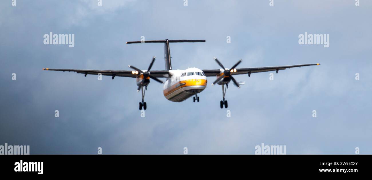 A plane is flying in the sky with it's landing gear down Stock Photo ...