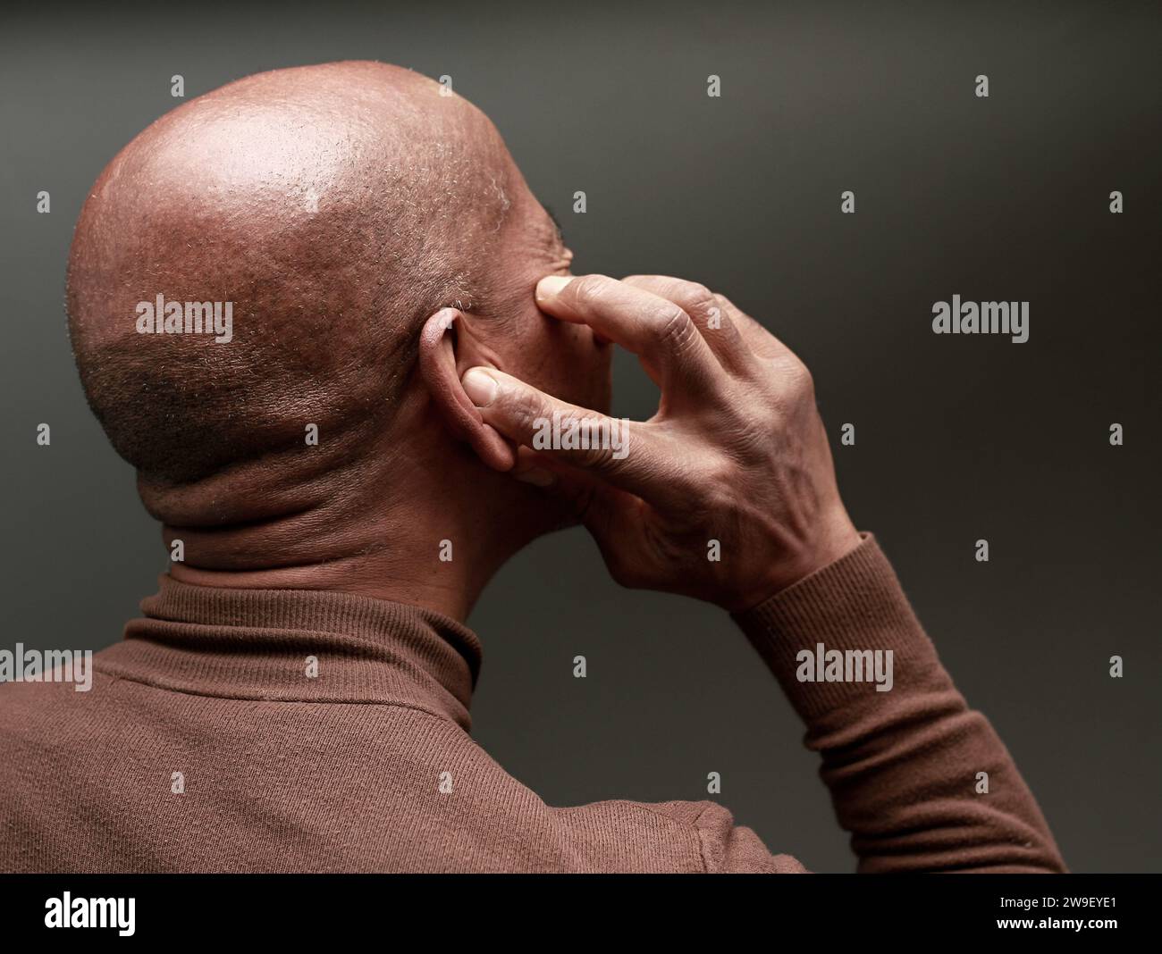 deafness suffering from hearing loss on grey black background with ...