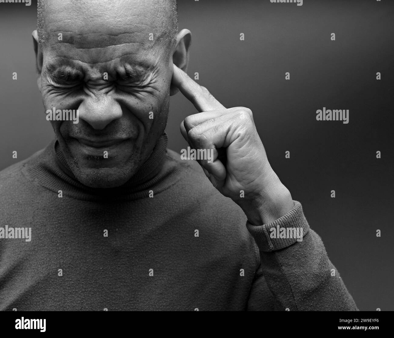 deafness suffering from hearing loss on grey black background with ...