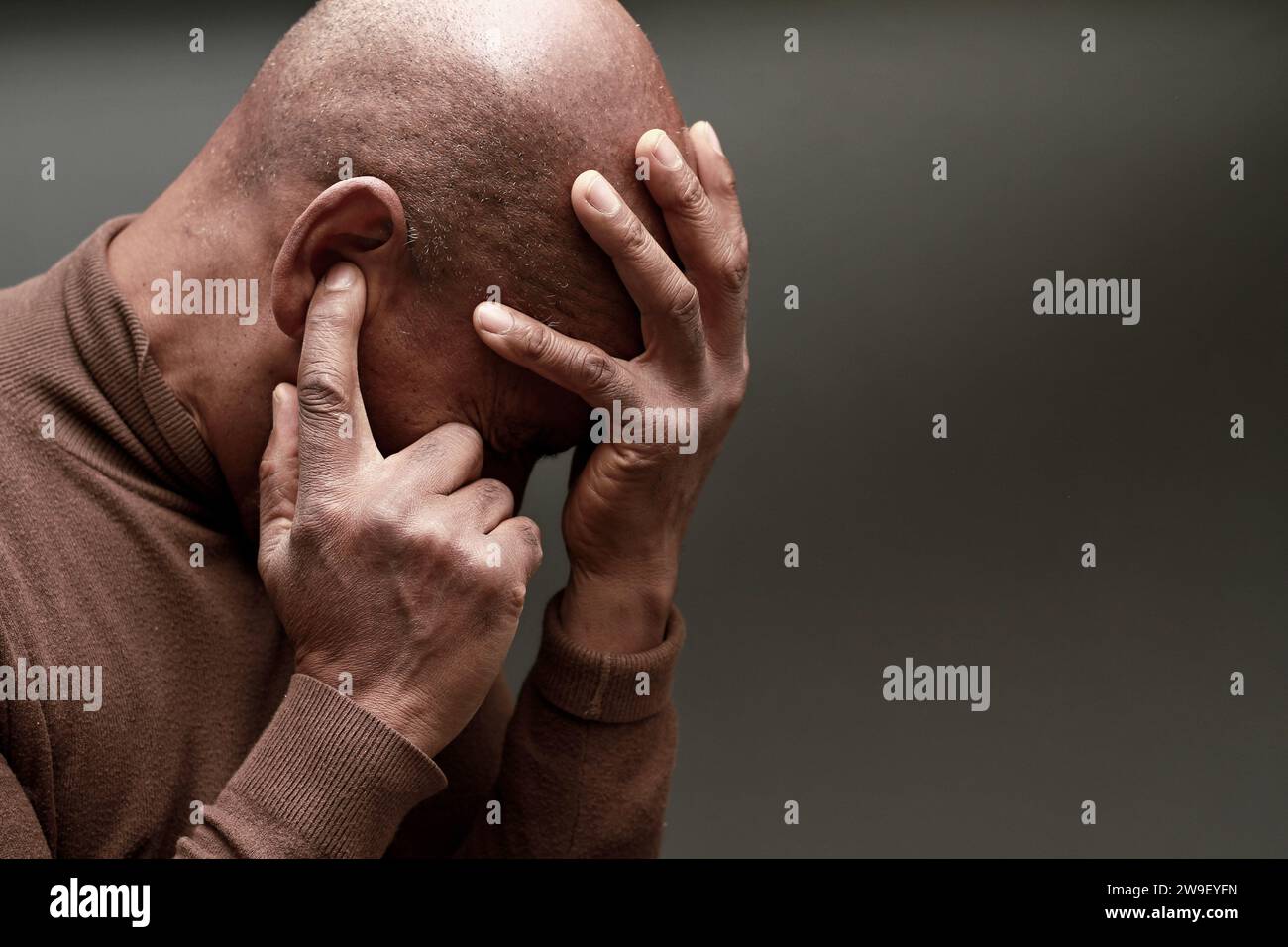 deafness suffering from hearing loss on grey black background with ...