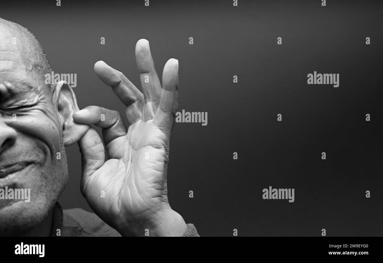 deafness suffering from hearing loss on grey black background with ...