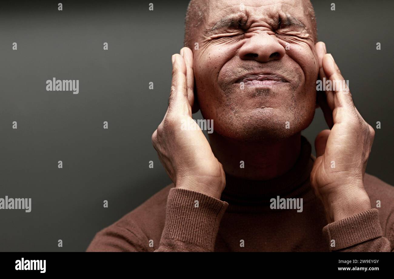 deafness suffering from hearing loss on grey black background with ...
