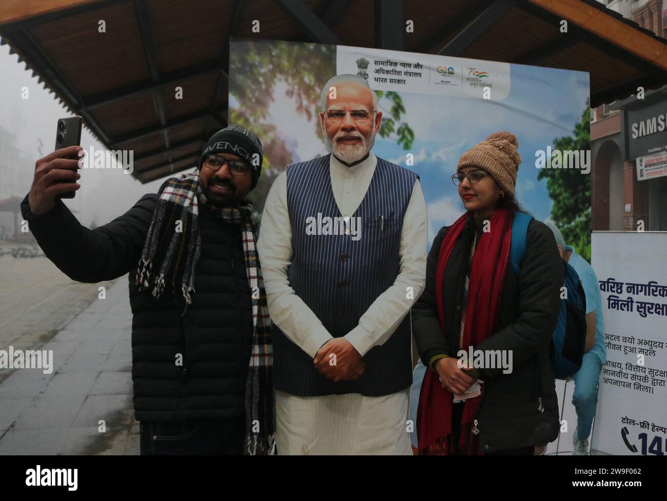 Srinagar Kashmir, India. 27th Dec, 2023. People take selfie pictures with a cutout portrait of ...
