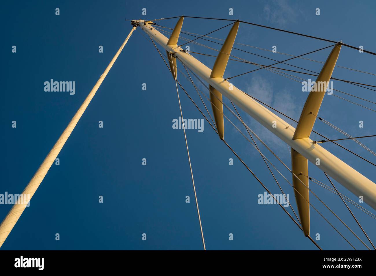 Mast and rigging onboard a large sailing yacht set against blue sky ...