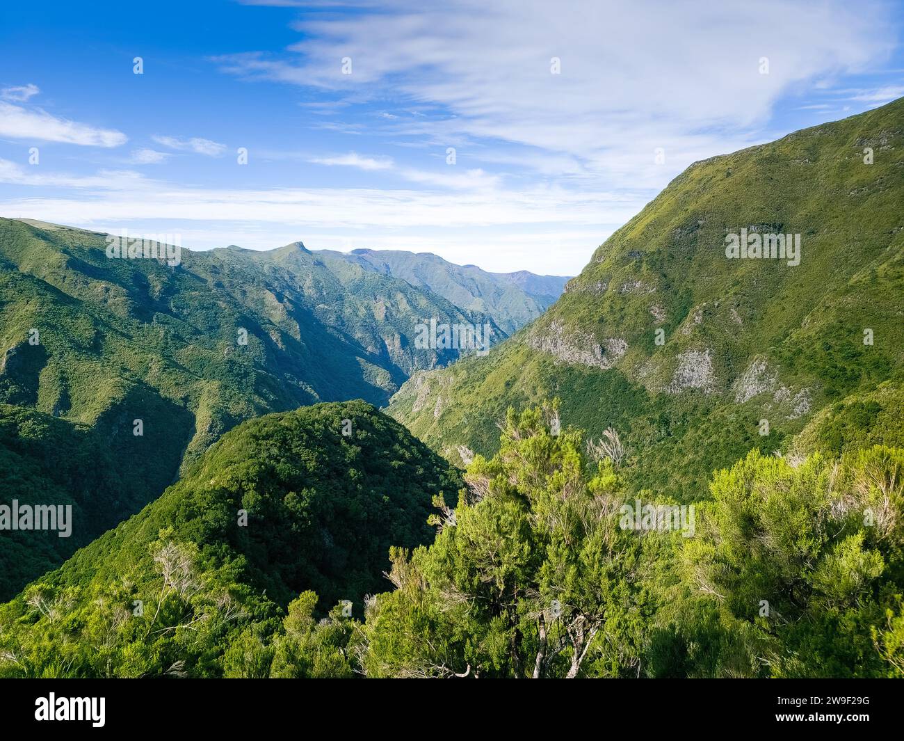 An aerial view of a breathtaking valley surrounded by majestic ...