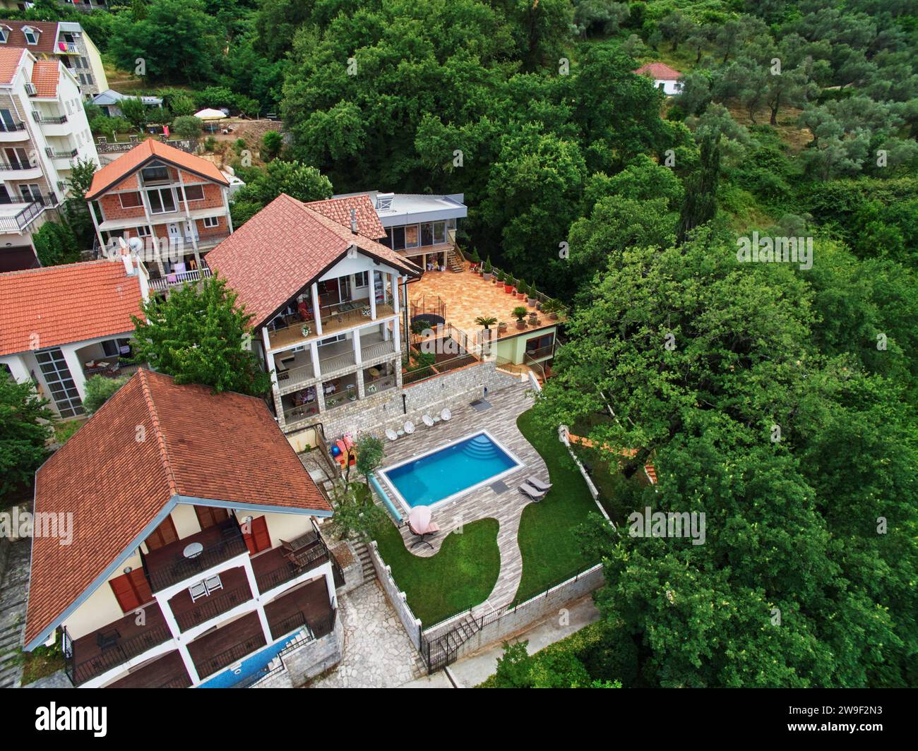 Cozy mansion with a swimming pool among green trees. Drone Stock Photo ...