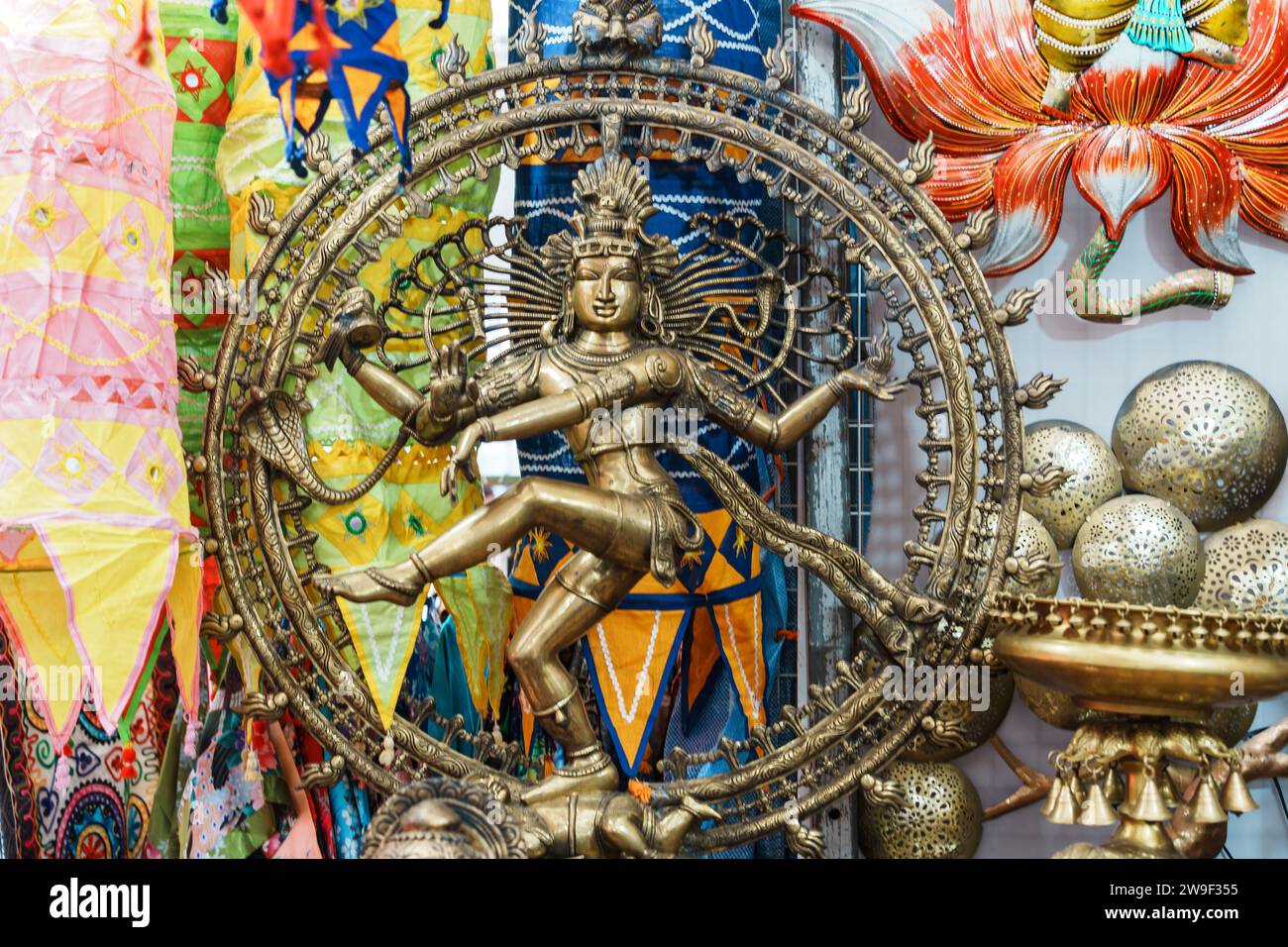 Two ornate brass statues prominently display on a background of bright ...