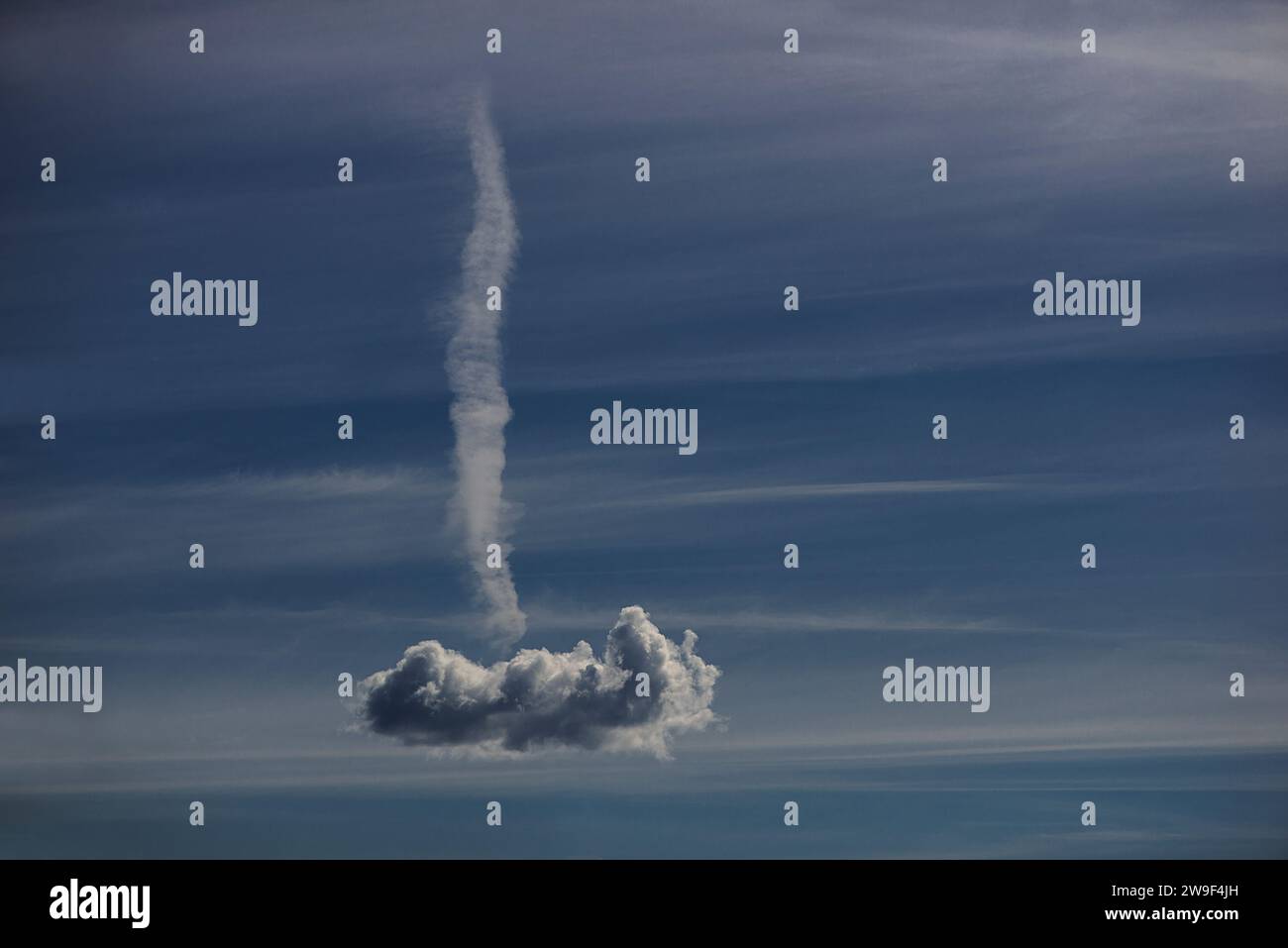 A white vaporous cloud in the shape of an aeroplane gliding through the ...