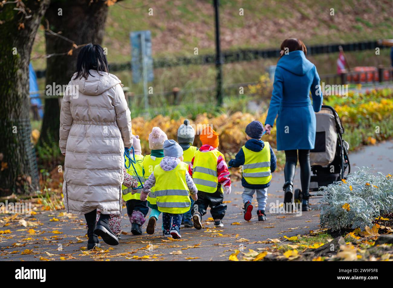 Riga, Latvia - November 4, 2022: A kindergarten teacher with small ...