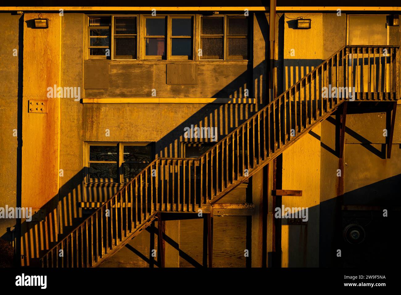 Fire escape casting shadow on the side of a building at dawn Stock ...