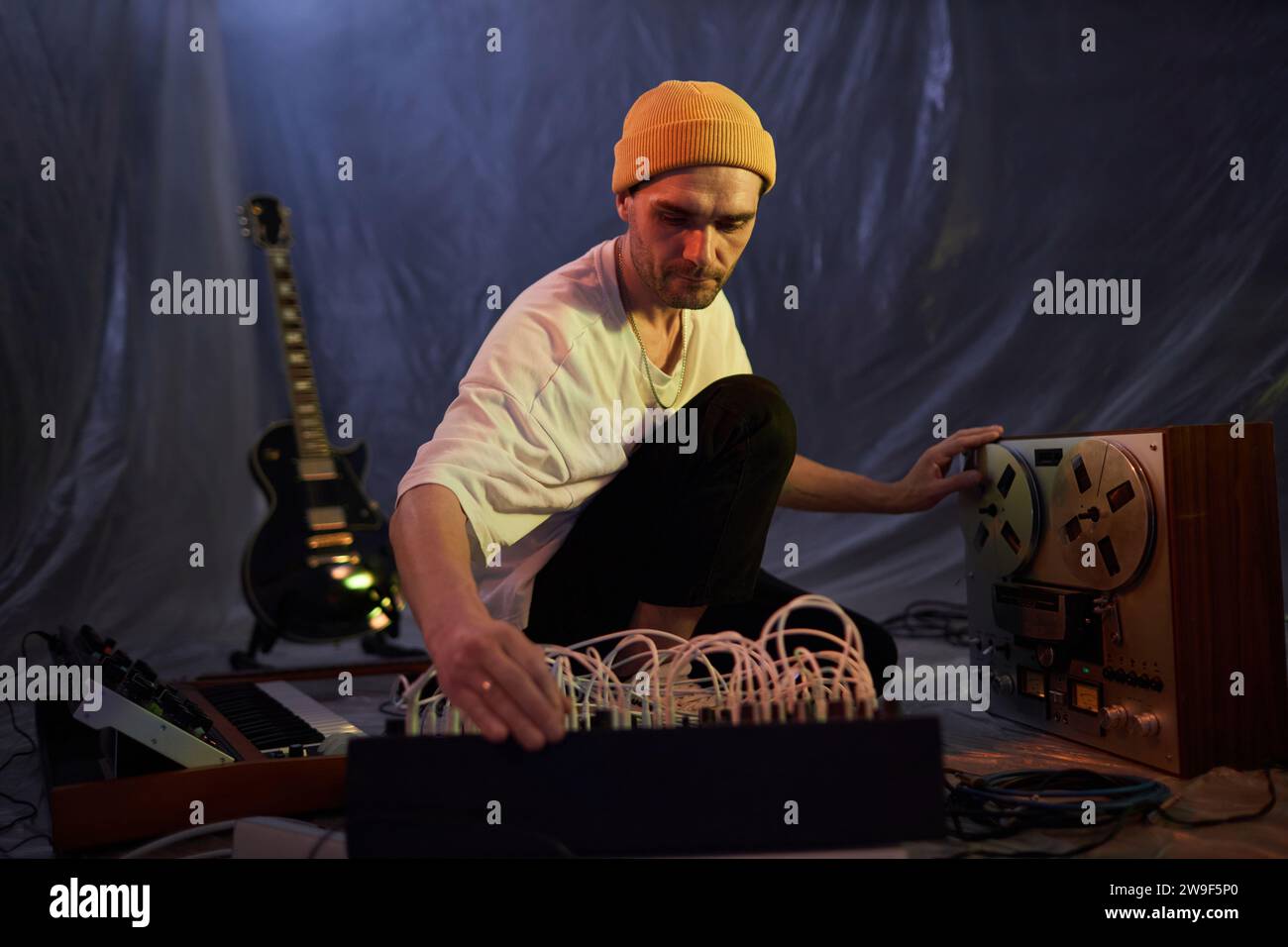 Composer Working on Analog Recording with Tape and Mixing Console Stock ...